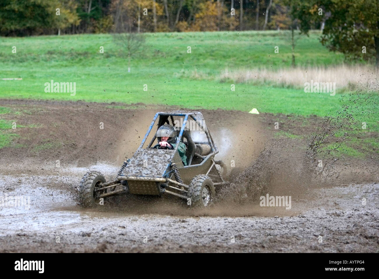 Buggy speeding through a mud puddle on outwards bound course Stock ...