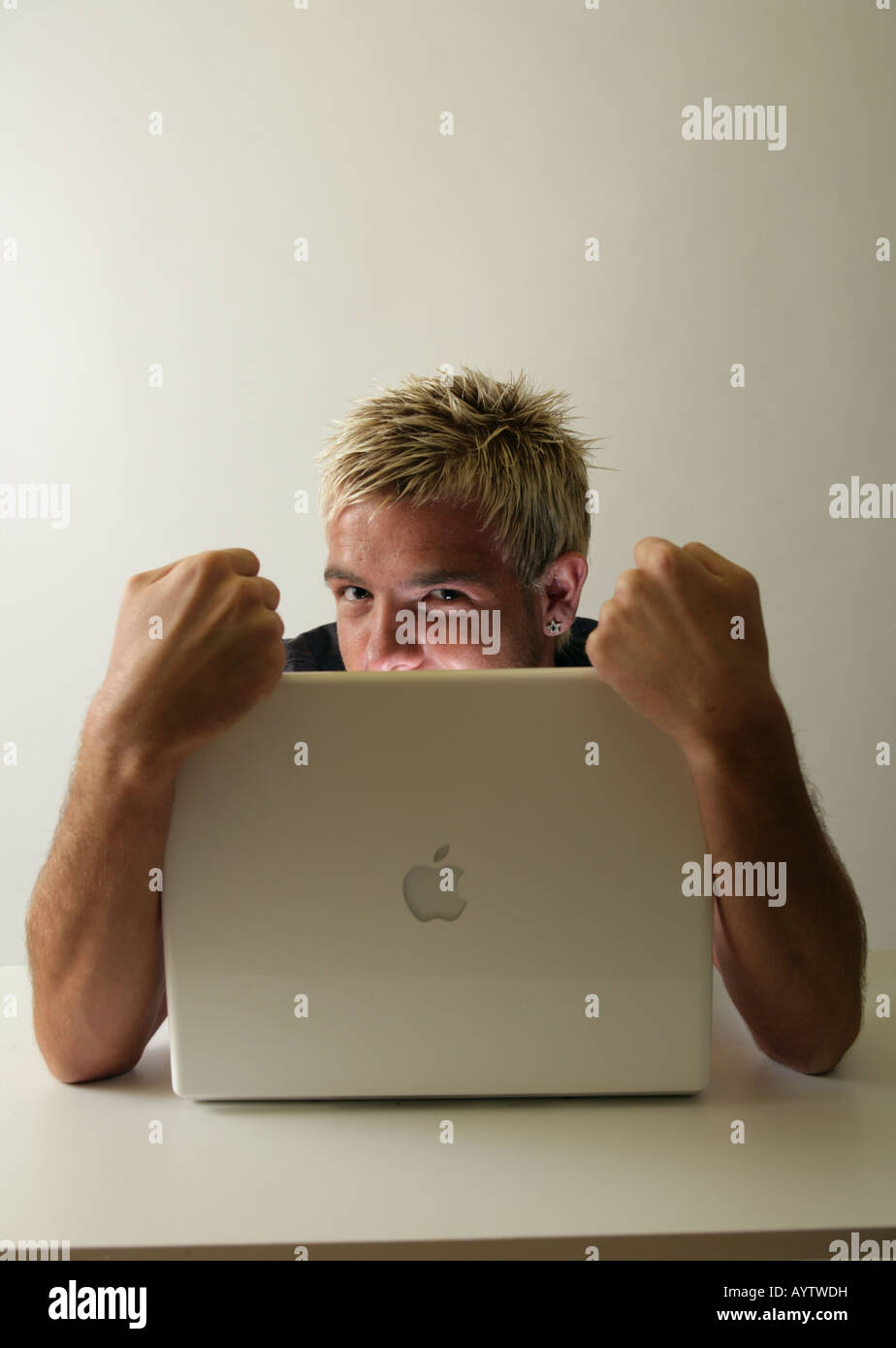 man holding onto a apple mac laptop Stock Photo - Alamy