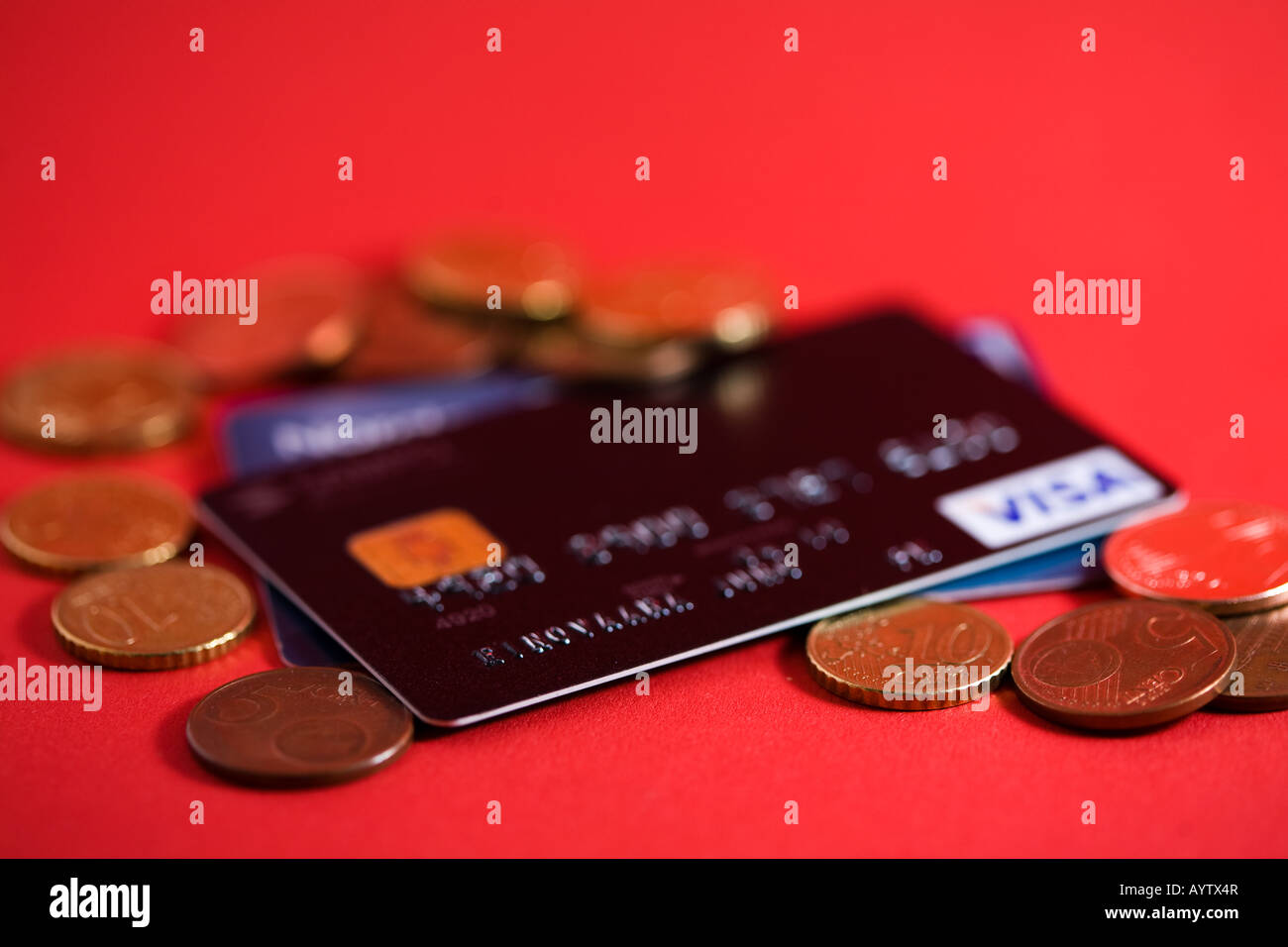 Credit card and Euro coins on a red background Stock Photo - Alamy