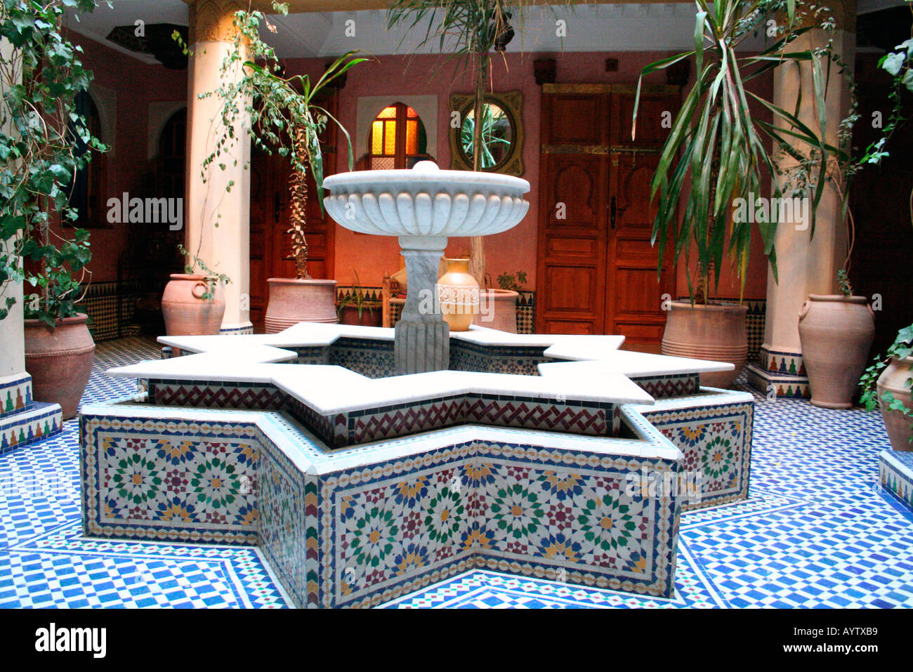 Moroccan riad, interior courtyard fountain of riad Jnane Mogador ...