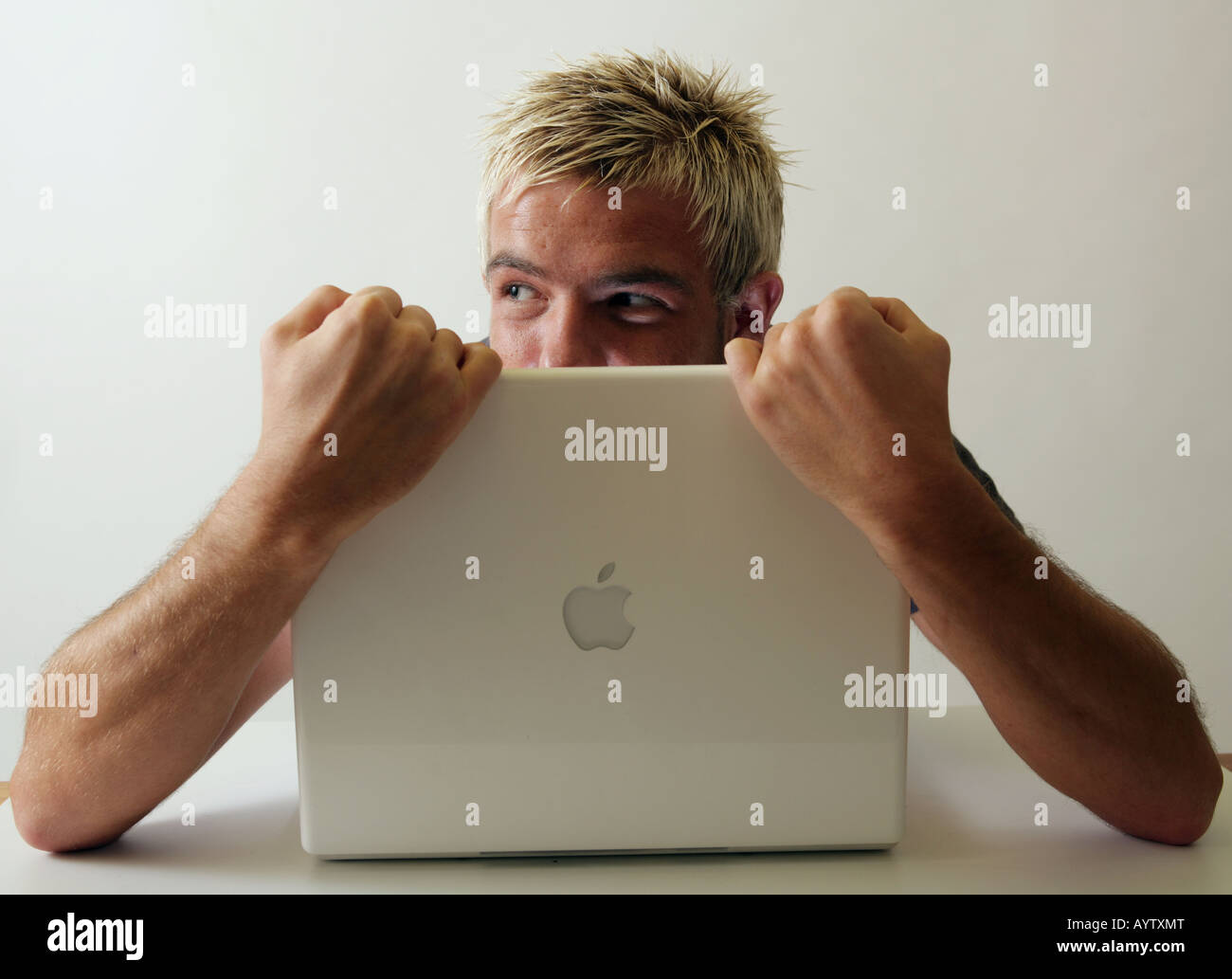 man holding onto a apple mac laptop Stock Photo - Alamy