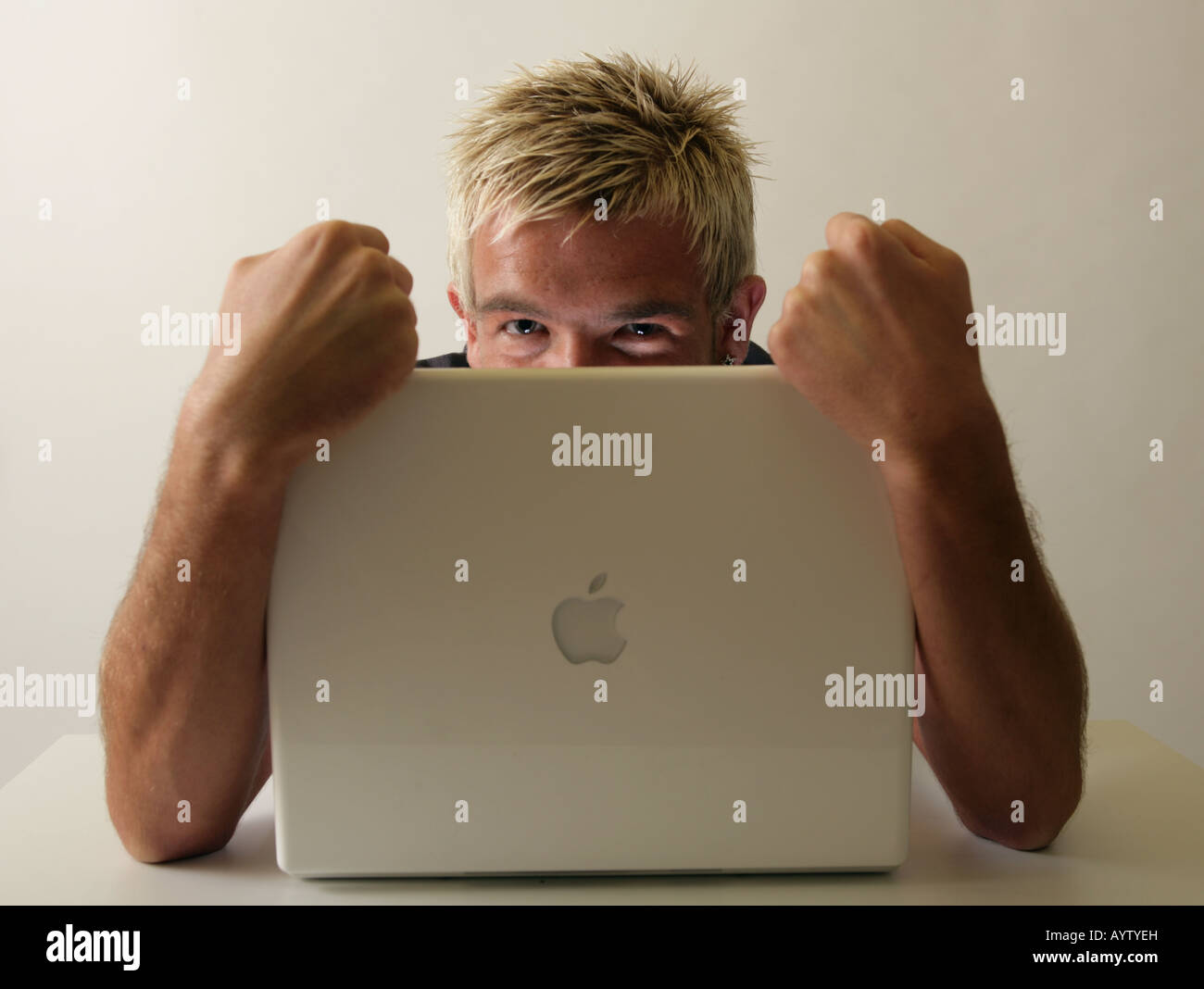 man holding onto a apple mac laptop Stock Photo - Alamy