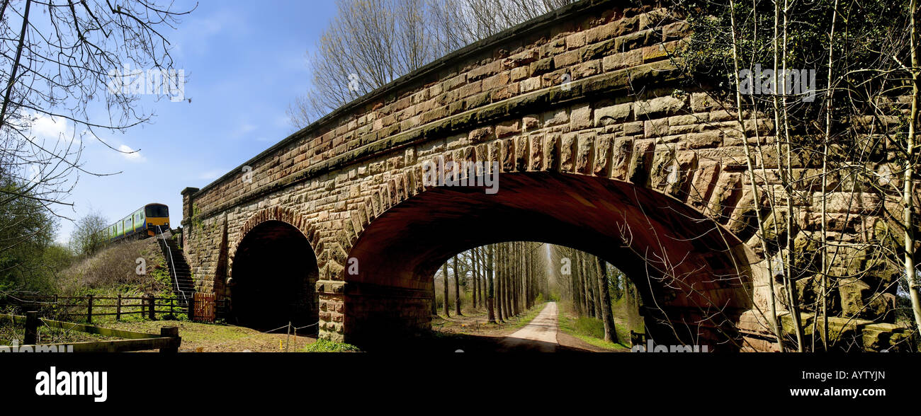 train approaching railway bridge over road country lane footpath ...