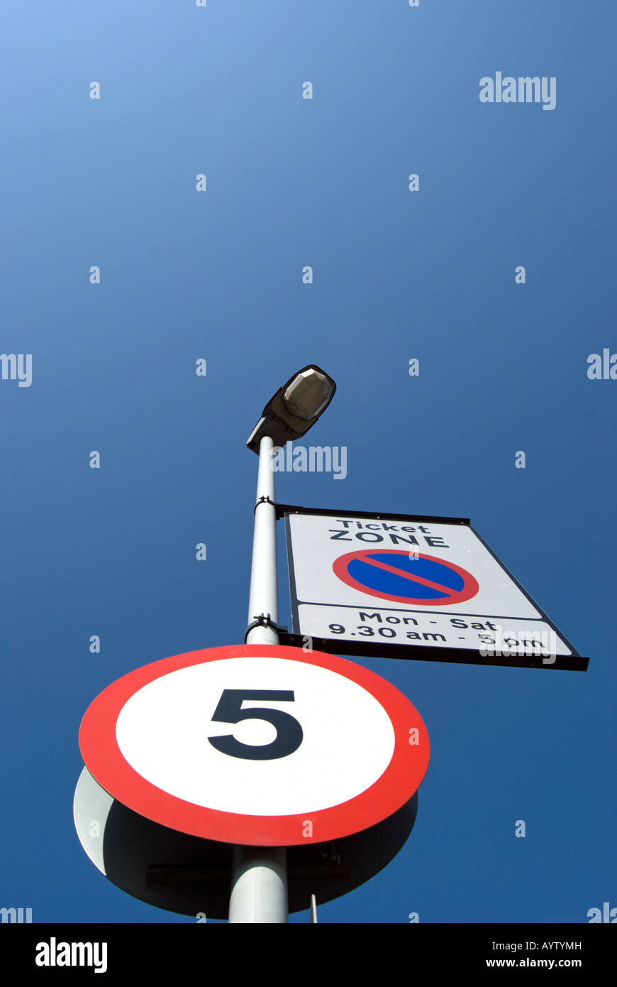 british road signs fixed to a lamppost indicating a five miles per hour ...