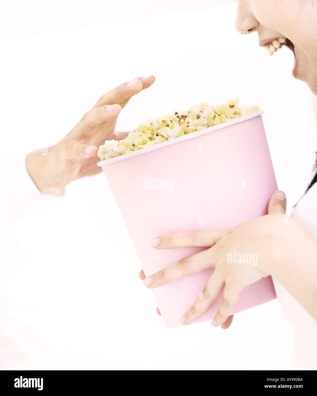 Hands holding bucket full of popcorn Stock Photo - Alamy