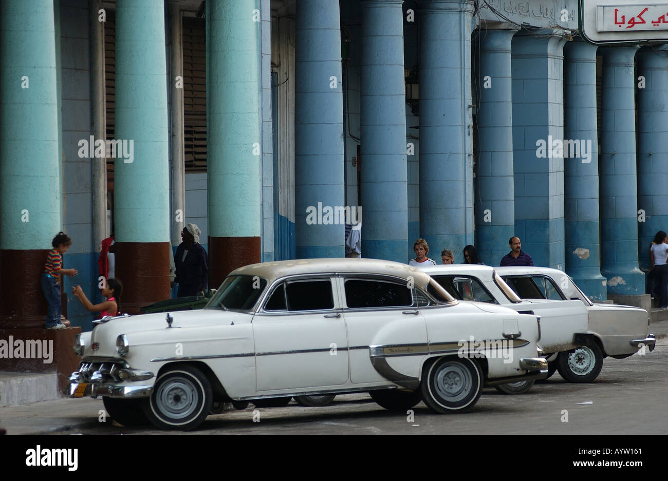 Side profile of antique cars parked outside a building Havana Cuba ...