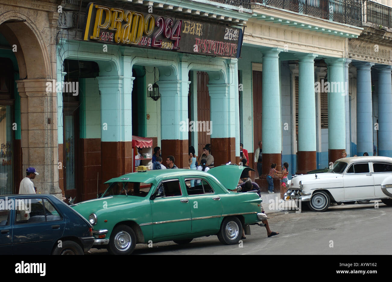 Side profile of antique cars parked outside a building Havana Cuba ...