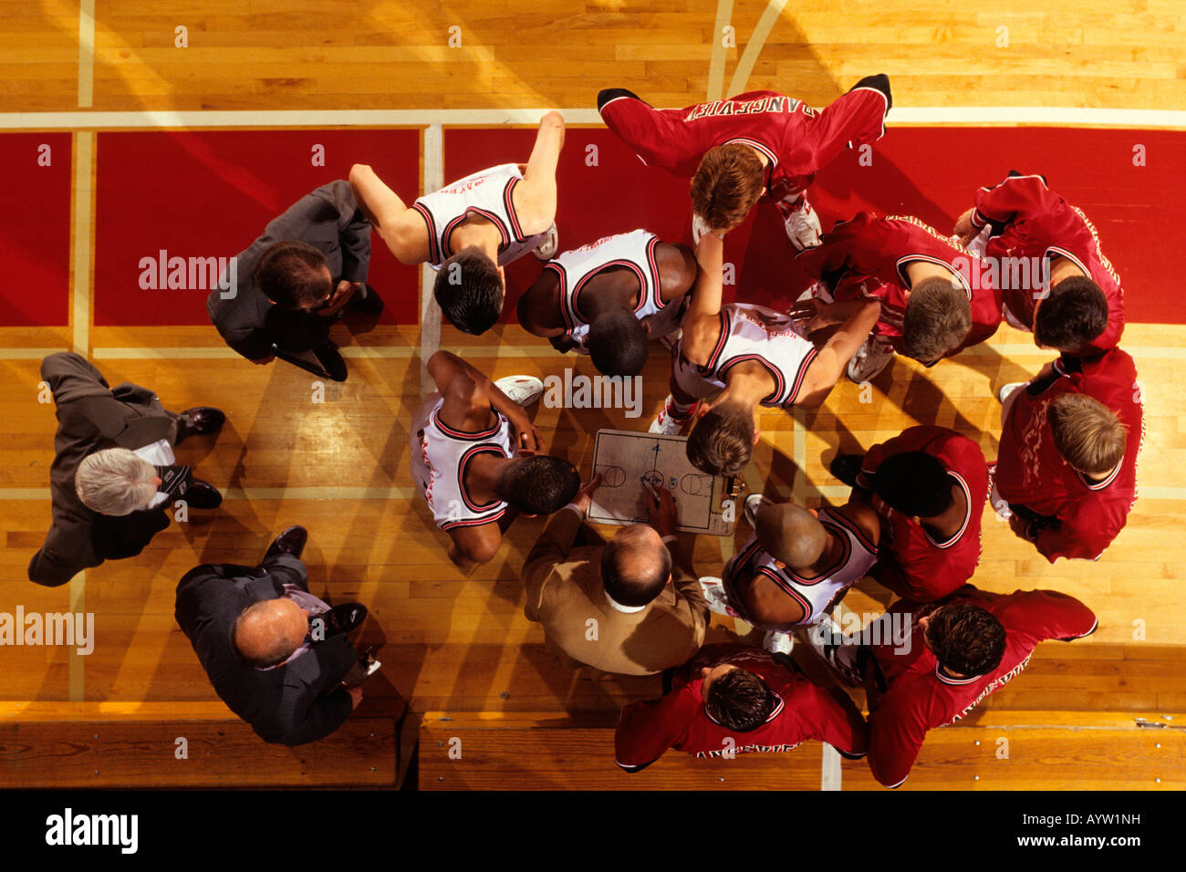 Overhead view of coach instructing High School basketball team Stock ...