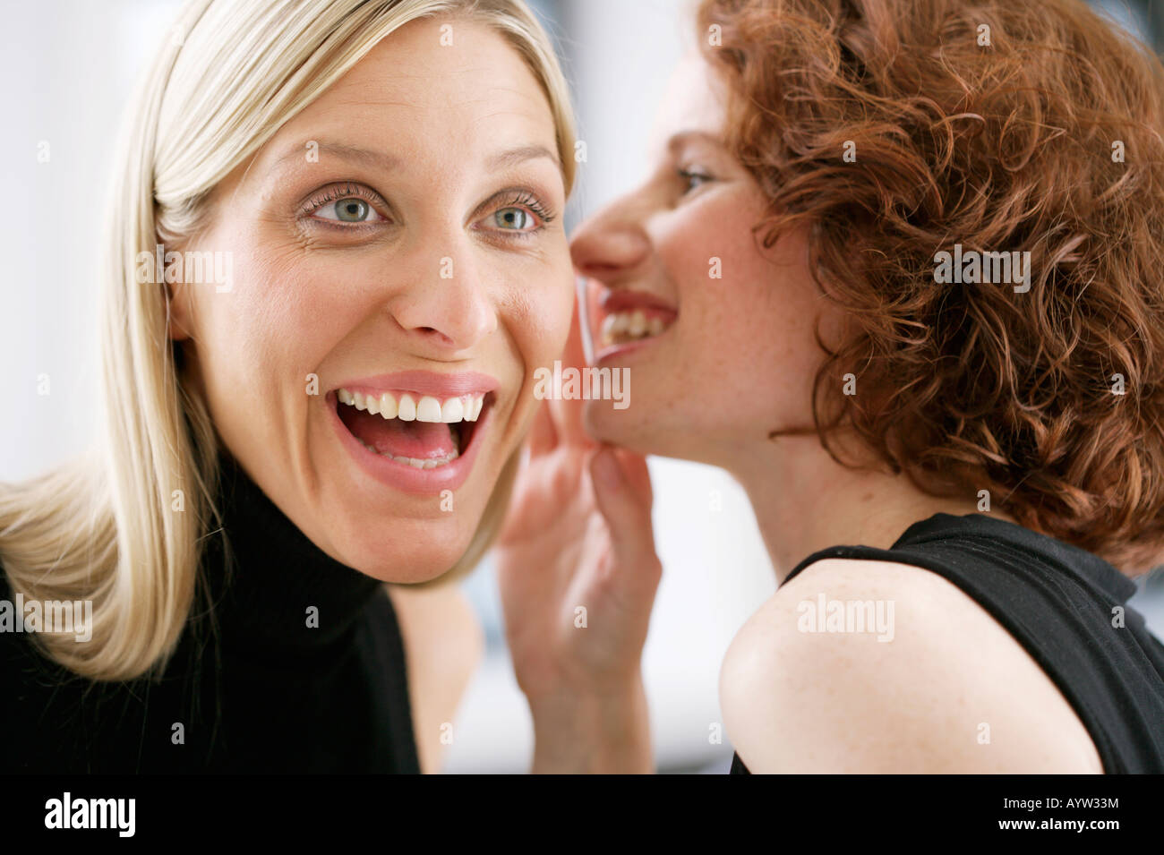 Two businesswomen whispering hi-res stock photography and images - Alamy