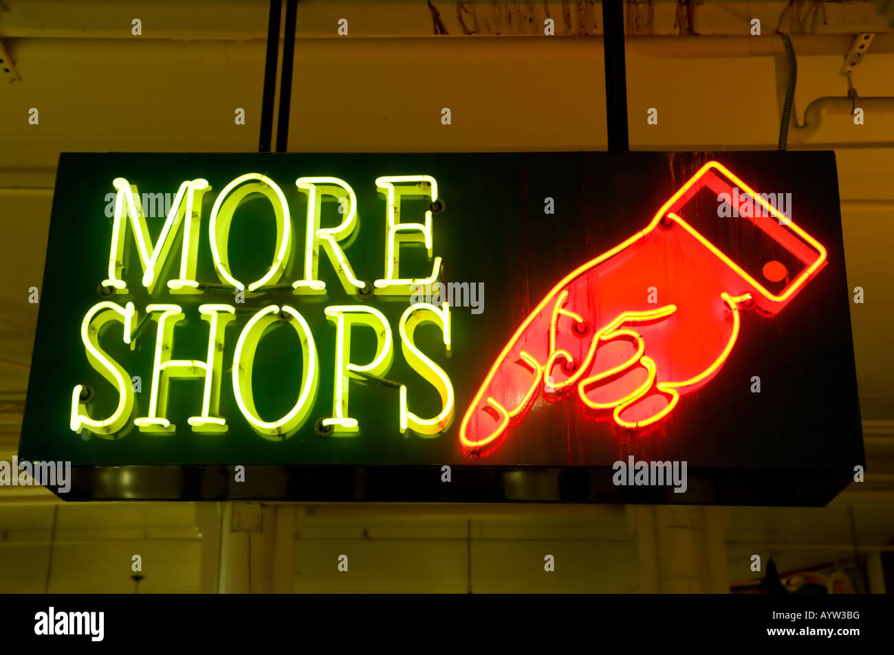 More Shops directional neon sign with a pointing finger at Pike Place ...