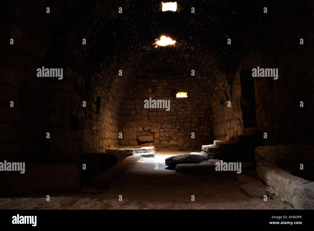 Light shining into illuminating the carved cut stone wall Karak, Kerak ...