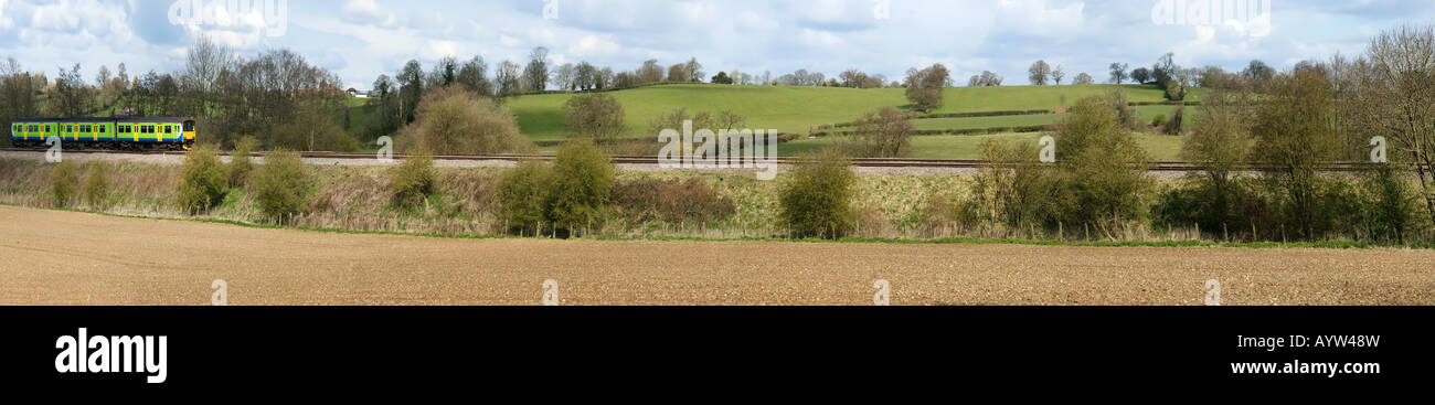 A train on a railway line in the countryside Stock Photo - Alamy