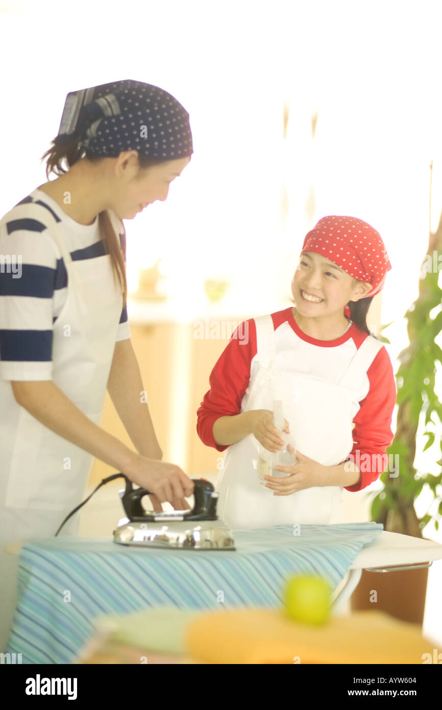 Mother and daughter ironing in the laundry room Stock Photo - Alamy