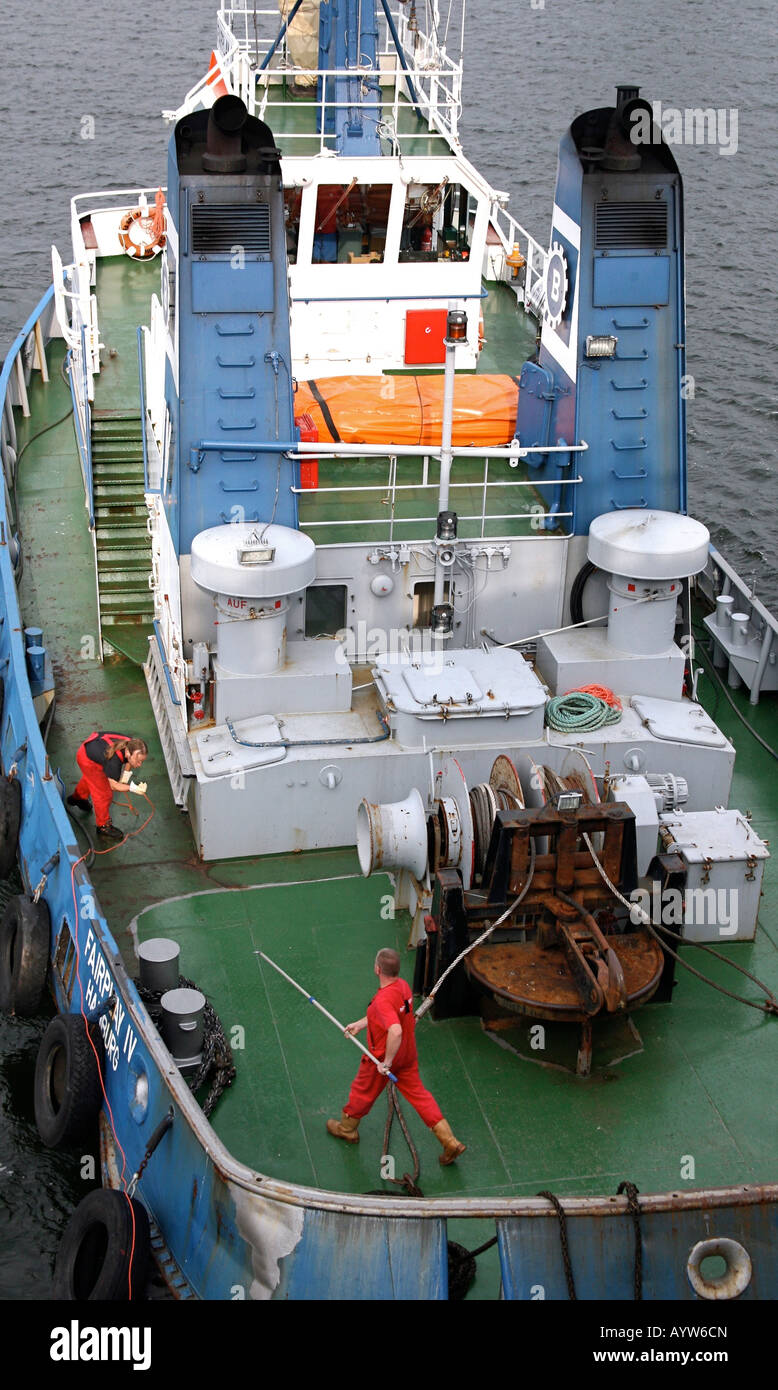 A tugboat with blue stacks, white body and green deck Stock Photo - Alamy