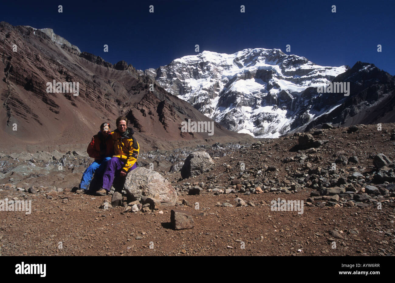 Trekkers sitting on rock facing front in Lower Horcones Valley en route ...