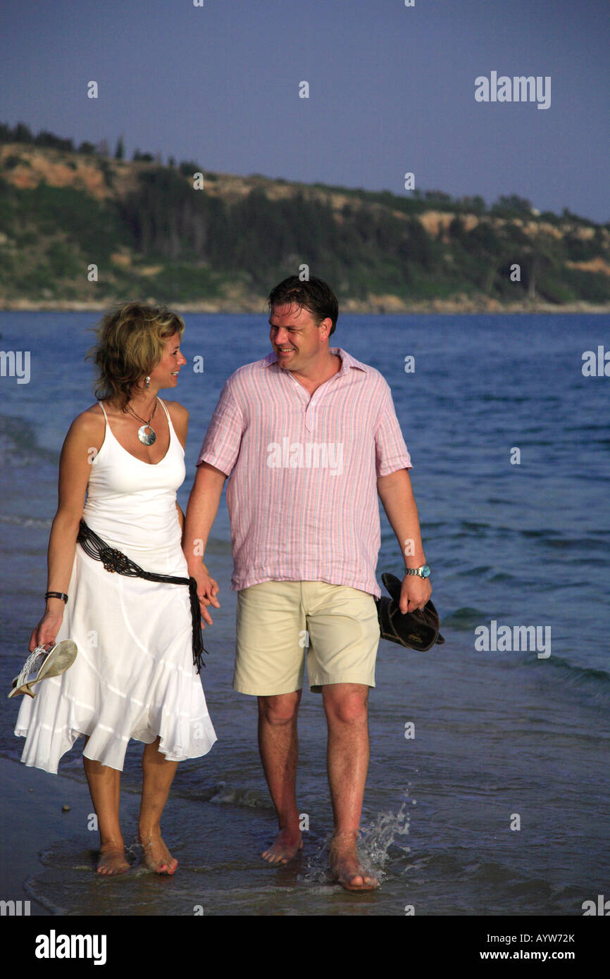A couple having a romantic stroll through the waves Kefalonia Greece ...