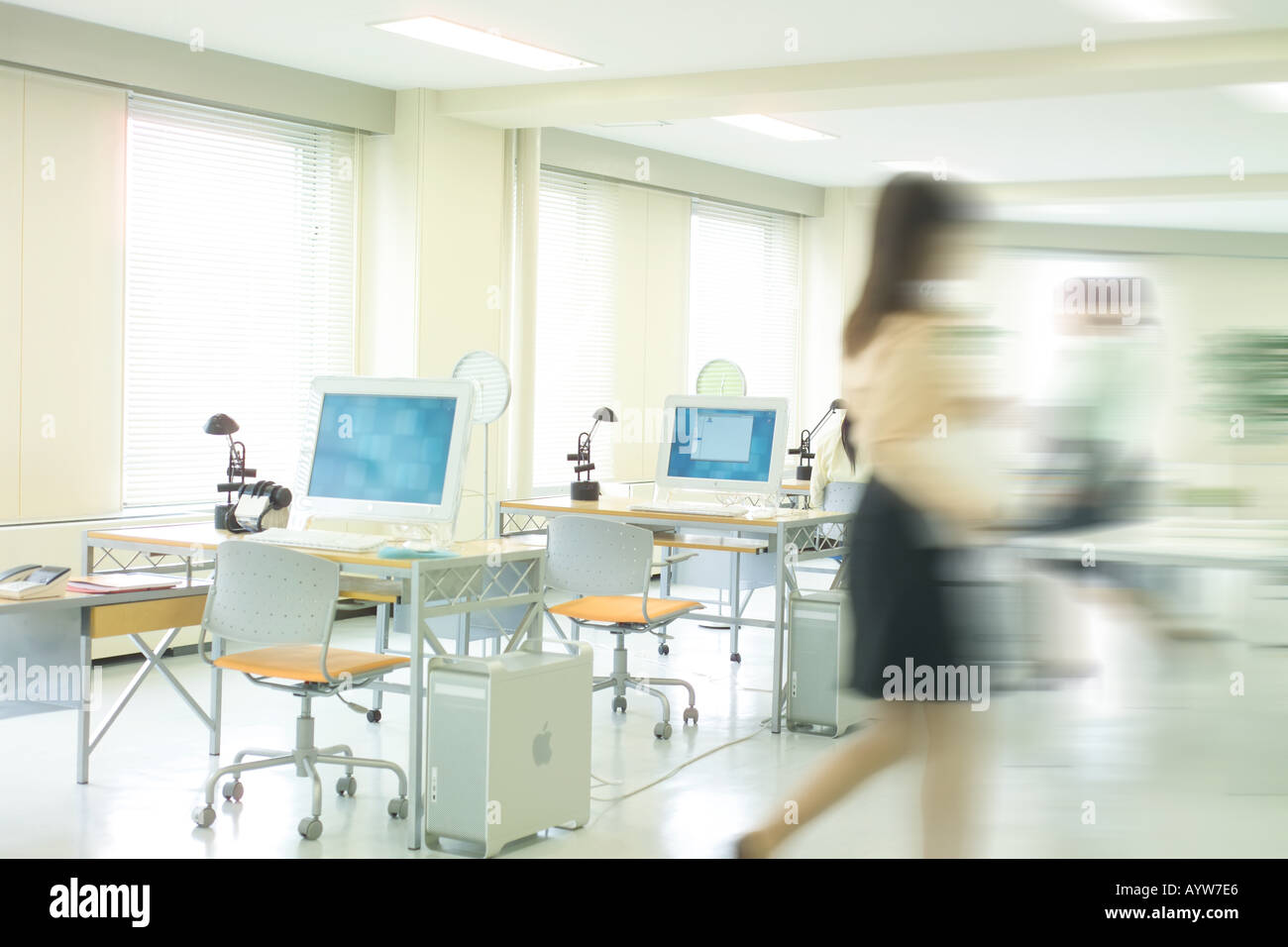 Woman running in a sophisticated office Stock Photo - Alamy