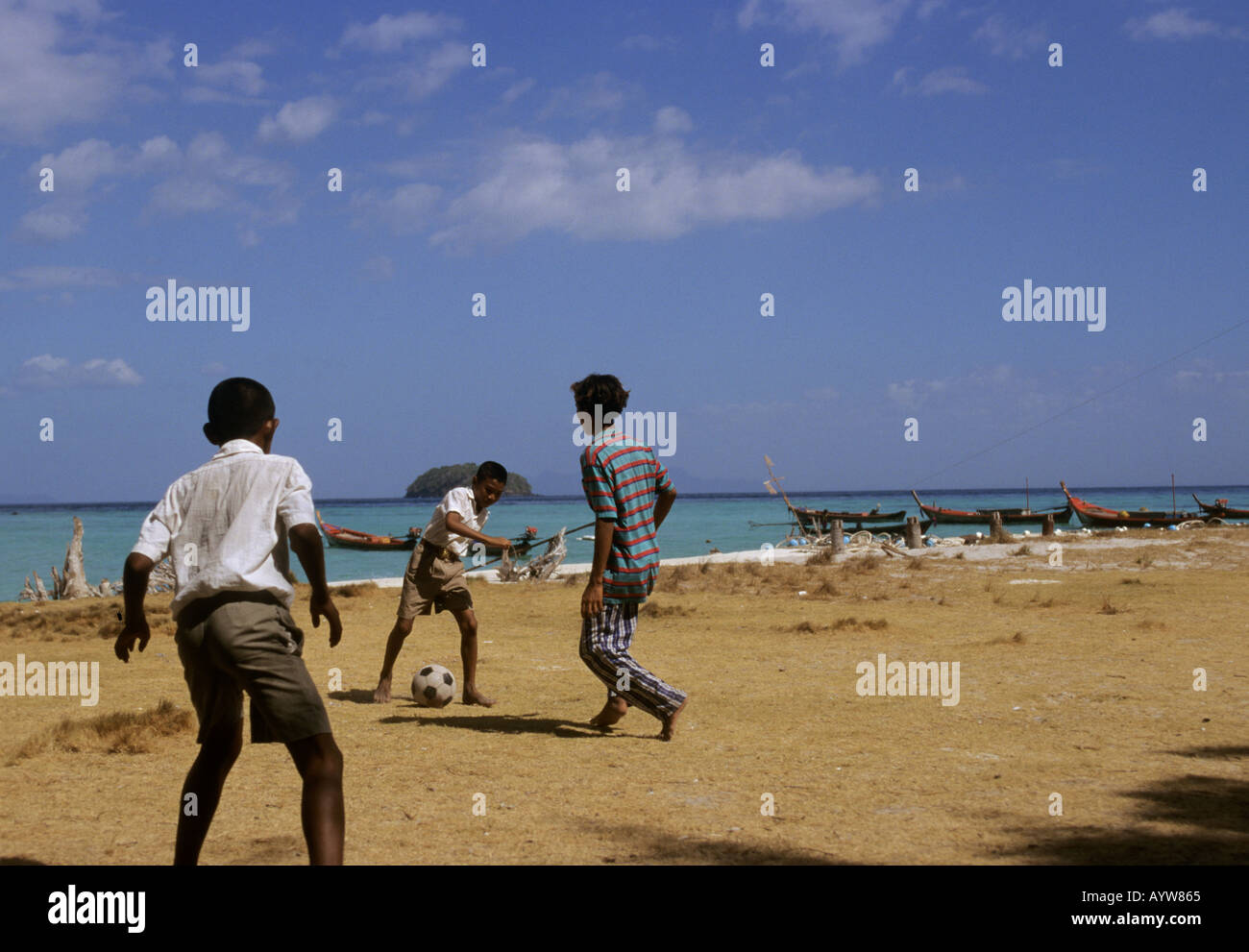 Chao Ley Sea Gipsy boys playing football Koh Lipe Andaman Sea Thailand ...