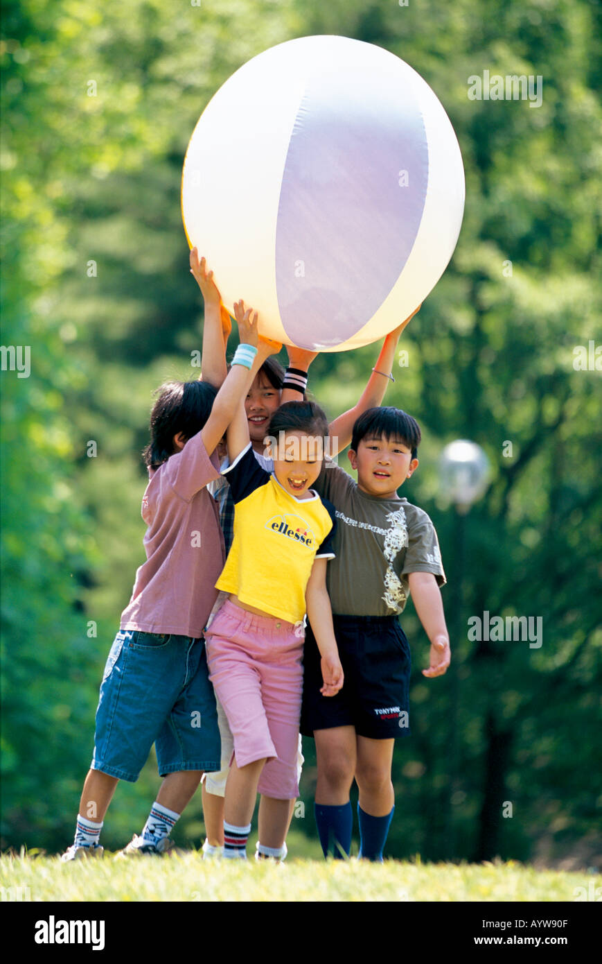 Children holding a big ball Stock Photo - Alamy