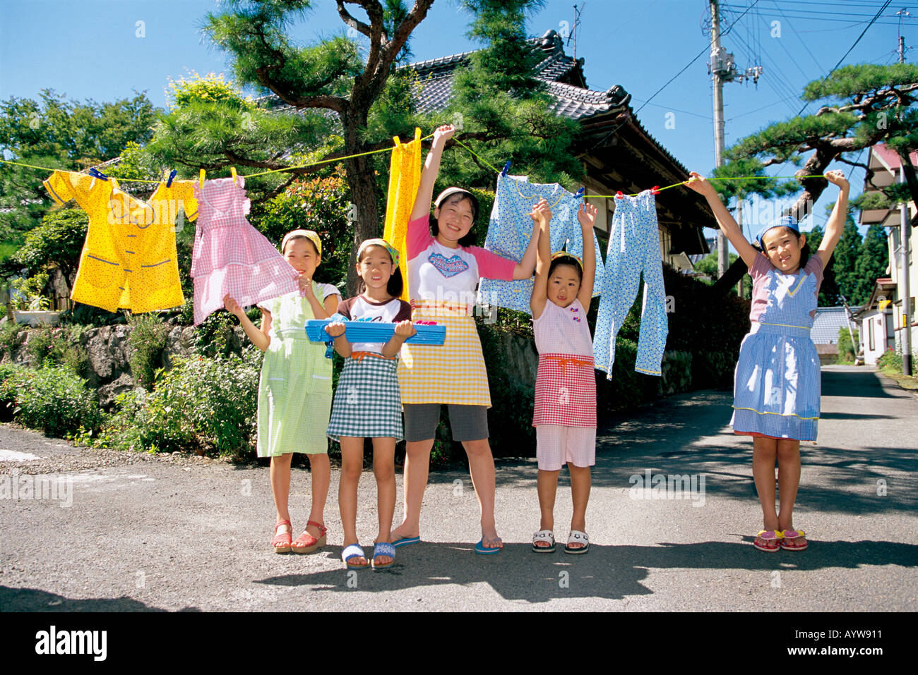 Children hanging up laundries to dry Stock Photo - Alamy