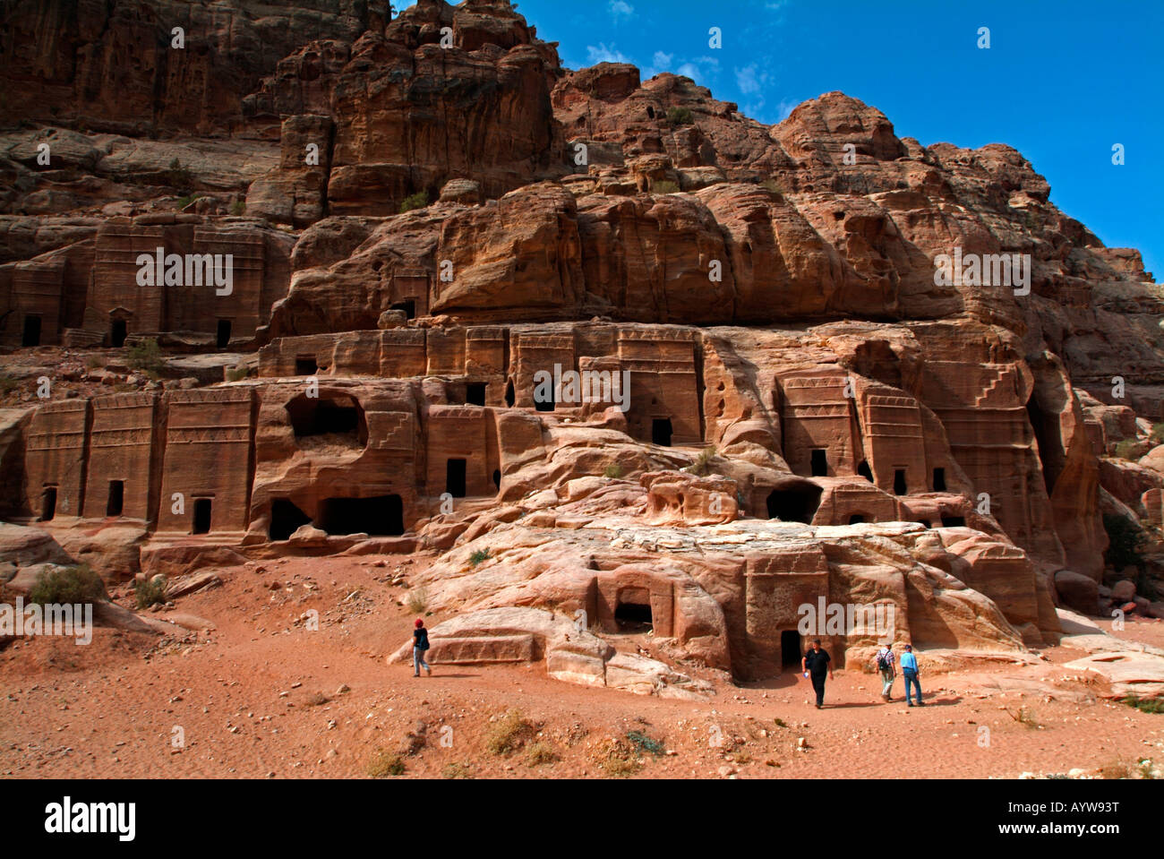 cliff cave dwelling carved into red sandstone cliffs at petra jordan ...