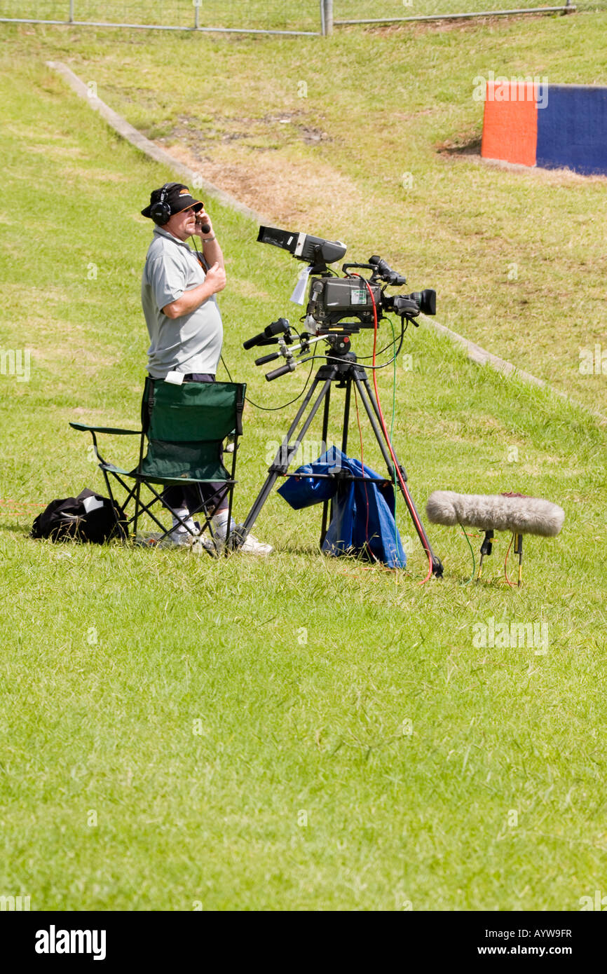 A video photographer and his video camera televising car racing Stock ...