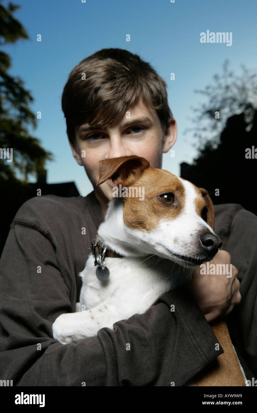 Boy holding an inquisitive jack russell dog Stock Photo - Alamy