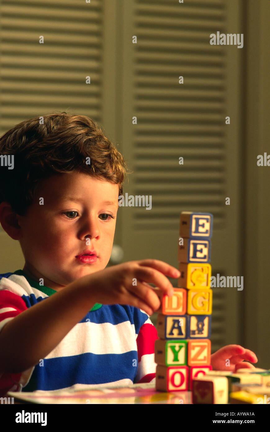 Small child playing with blocks Stock Photo - Alamy