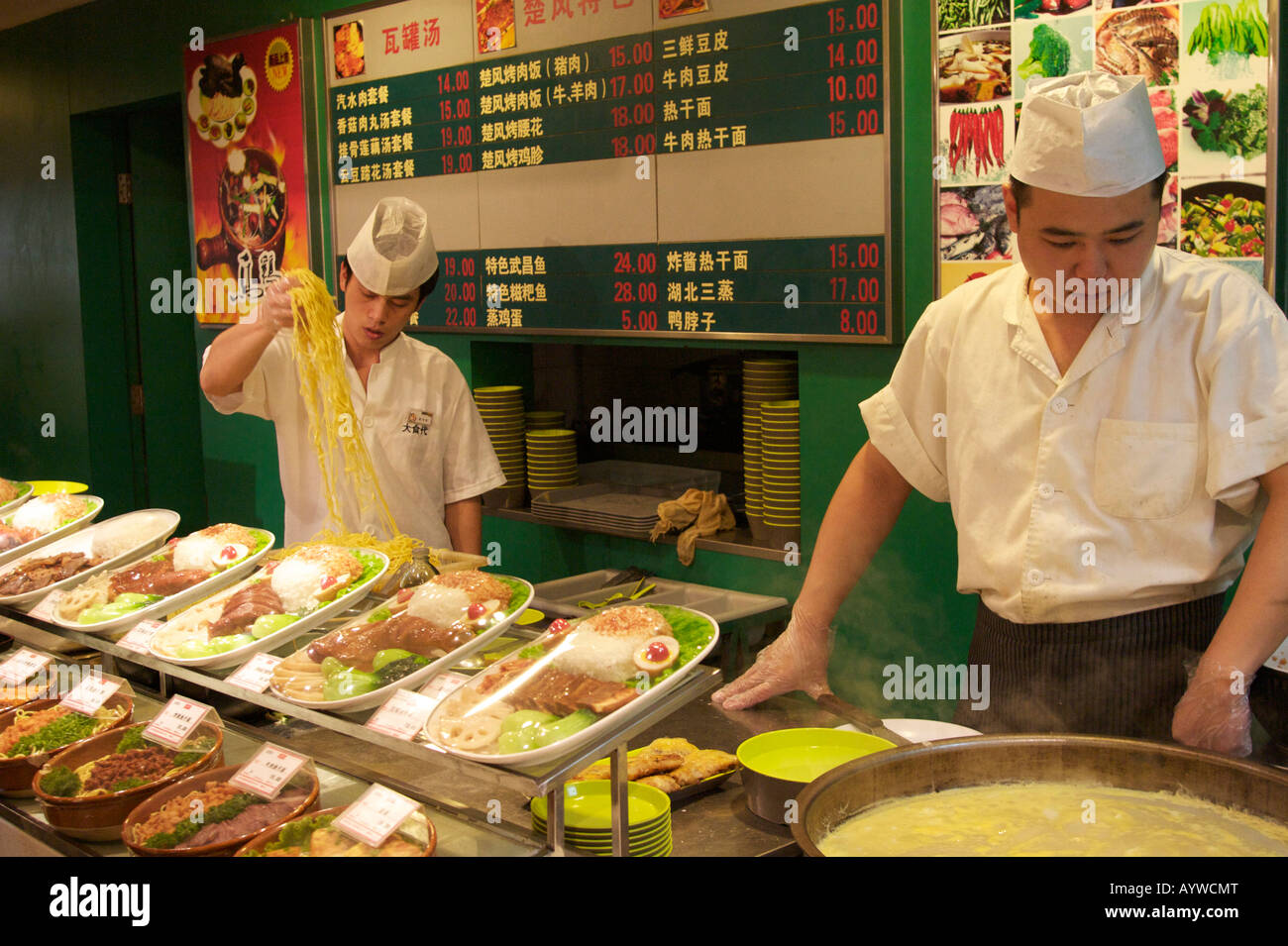 Chefs preparing noodle dishes at the food hall of the Oriental plaza ...