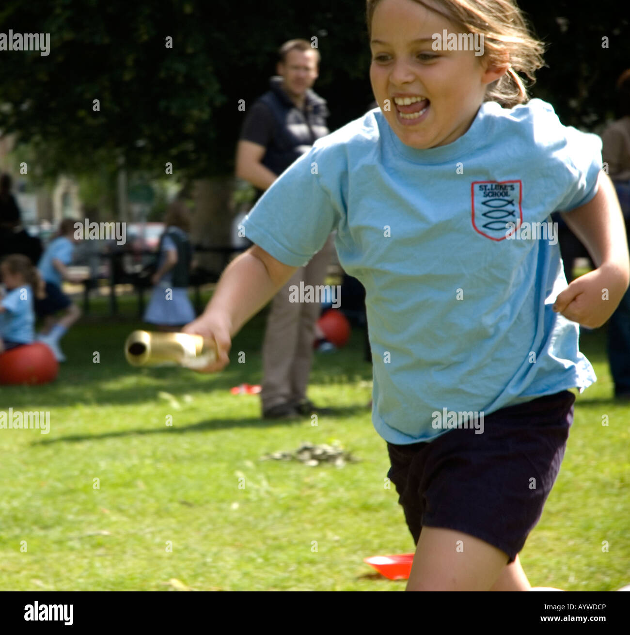 Young girl (aged 7) running in school relay race Stock Photo - Alamy