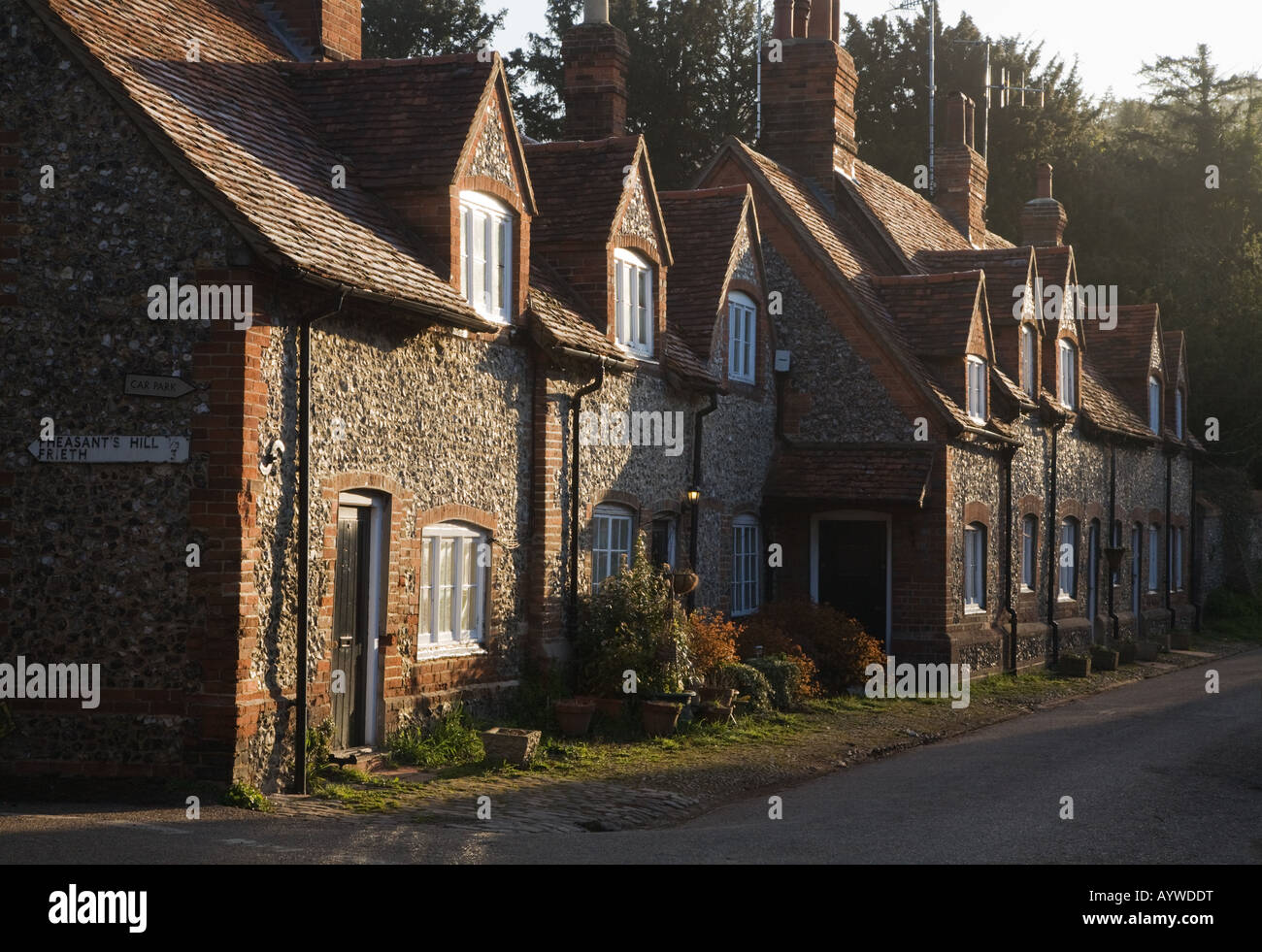 A row of traditional terraced Buckinghamshire brick and flint built ...