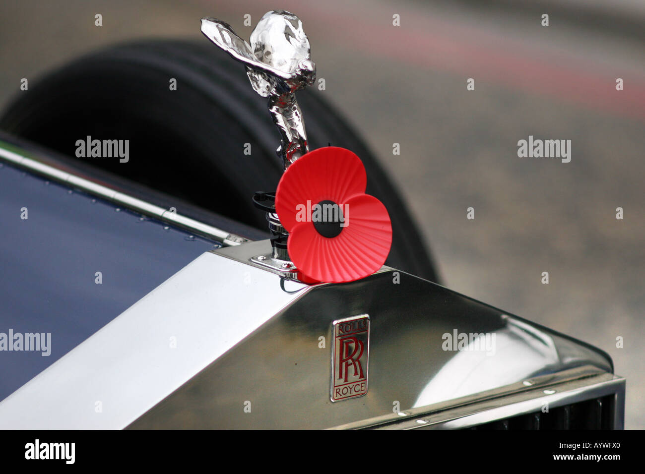 Rolls Royce Flying Lady emblem and a Red rememberence day Poppy Stock ...