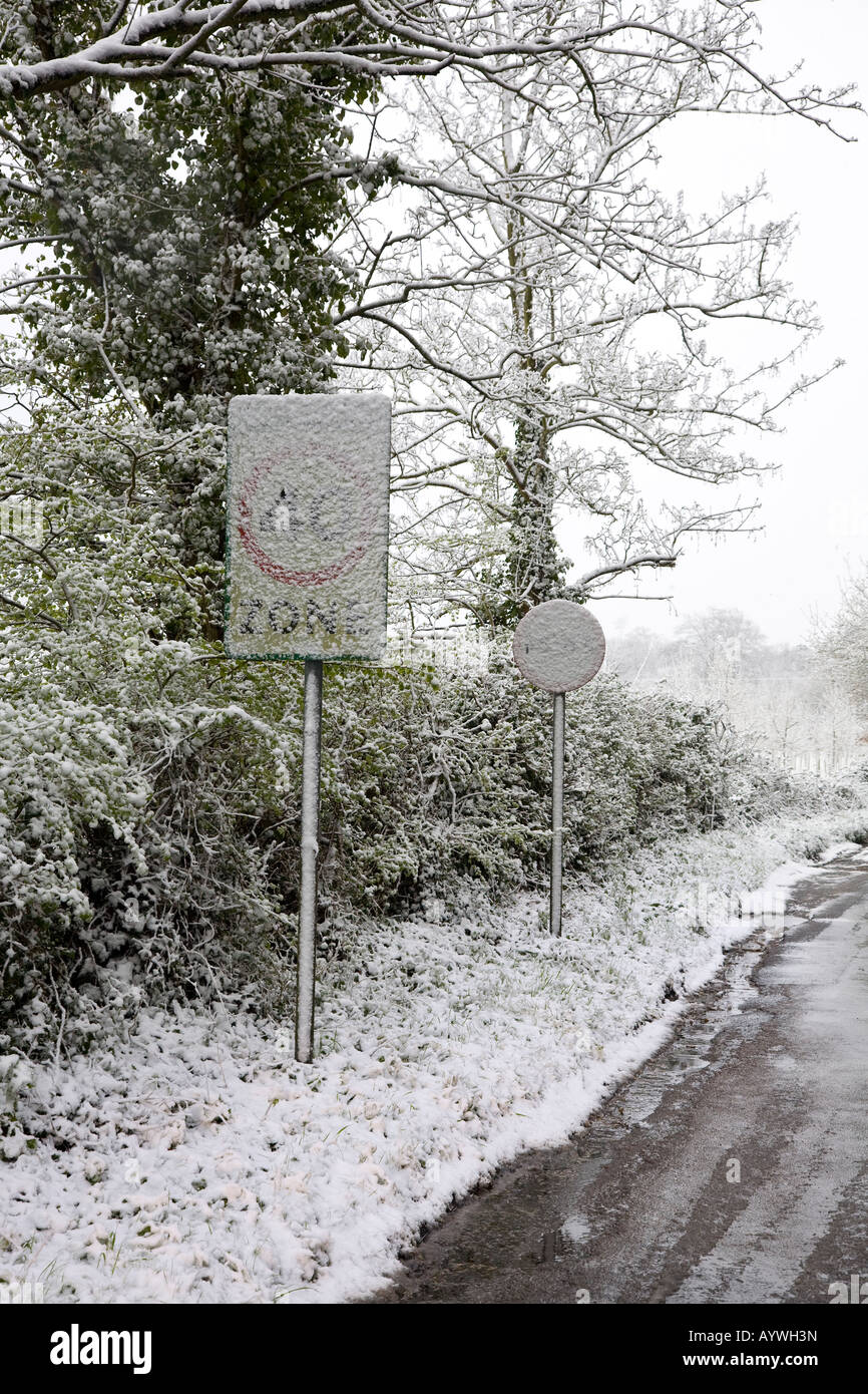 Snow covered road sign in country lane Stock Photo - Alamy