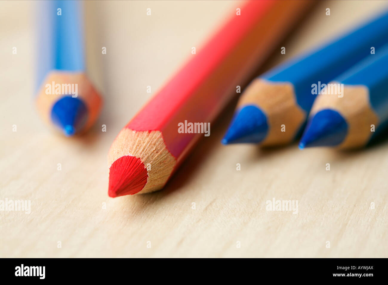 A red colored crayons between blue ones Stock Photo - Alamy
