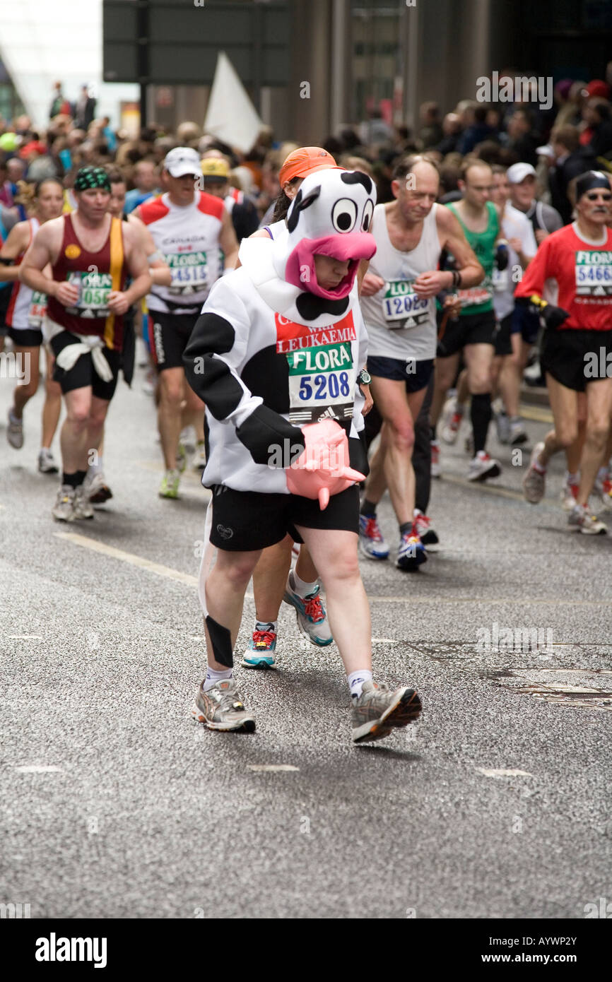 Fancy dress runners a man dressed as a cow at the London Flora Marathon ...