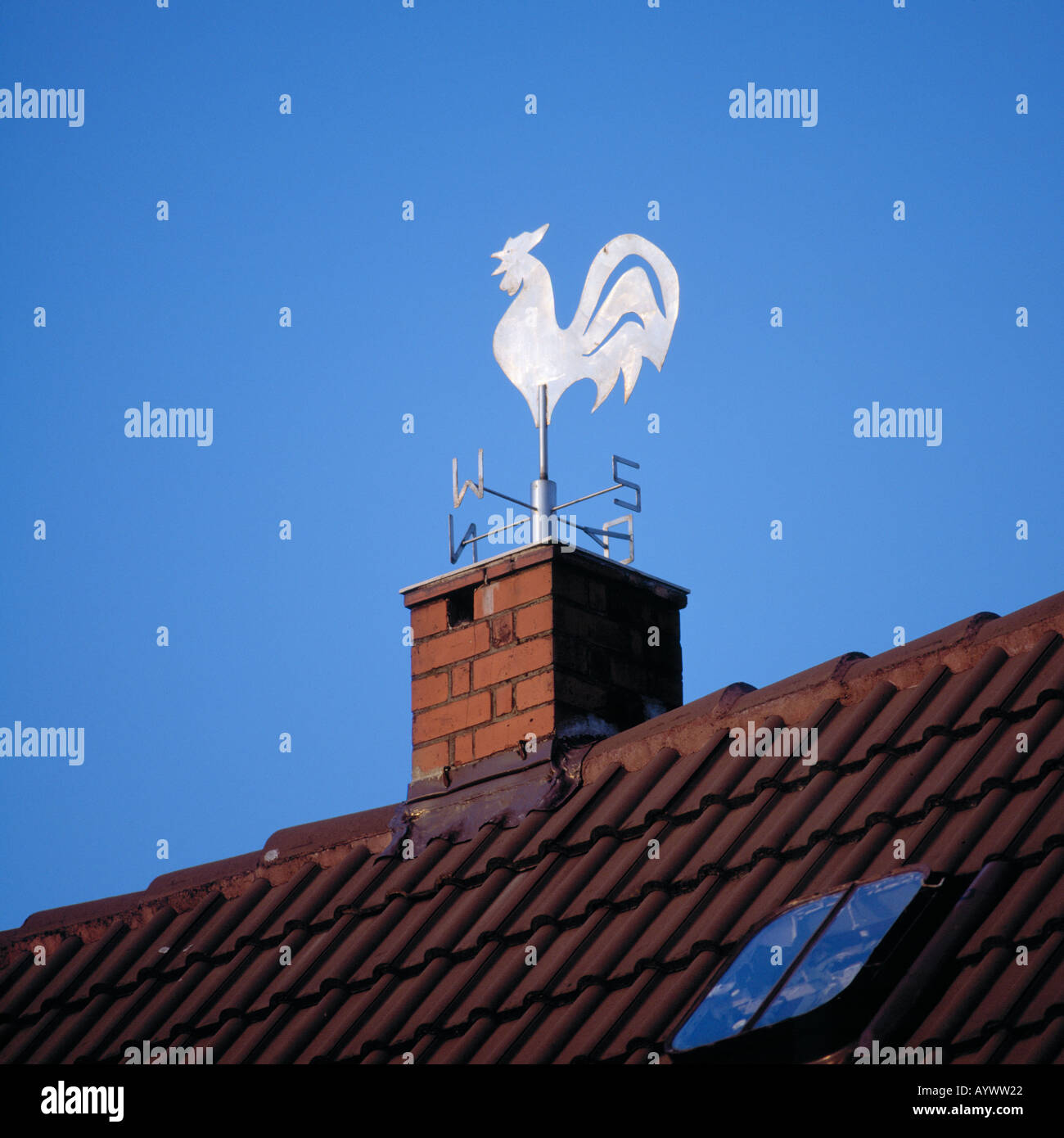 weathercock on a house roof, blue sky, marking, mark shows point of the ...