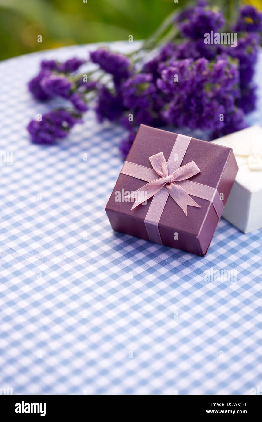 Gift and flower on the table Stock Photo - Alamy