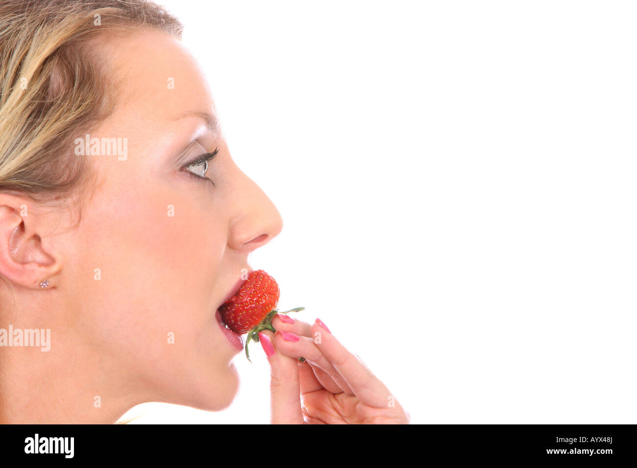 Young Woman Eating a Strawberry Model Released Stock Photo - Alamy