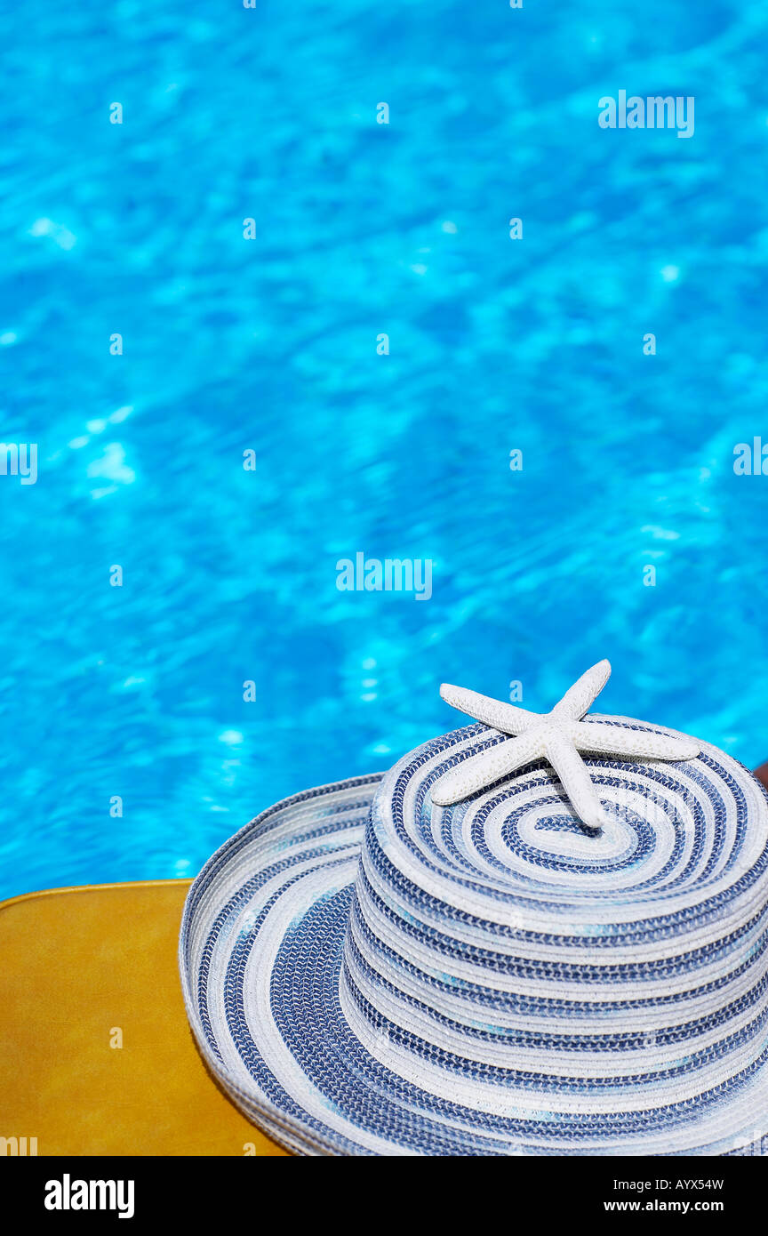 starfish and hat on the blue wave Stock Photo - Alamy