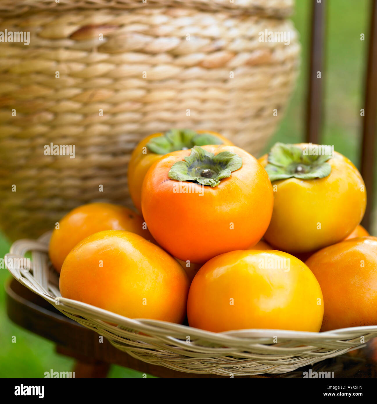 basket with persimmon on the chair Stock Photo - Alamy