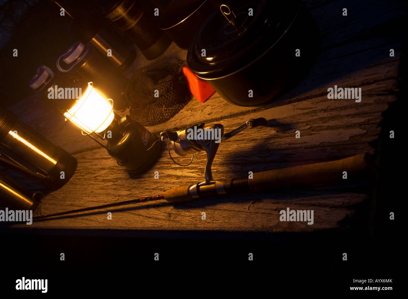 A COLEMAN ILLUMINATES A FISHING POLE AND REEL IN THE EARLY MORNING BIG ...