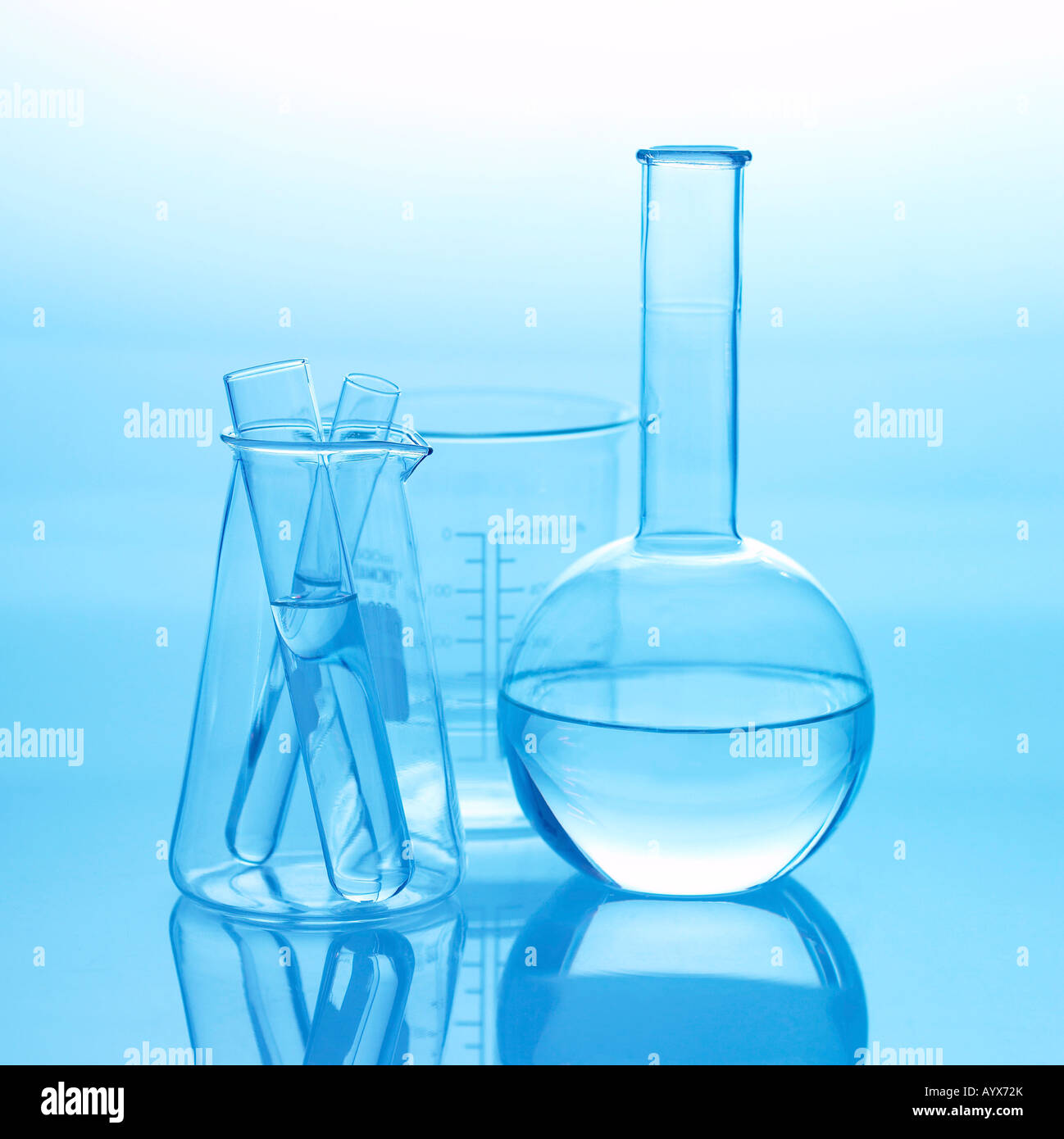beaker with liquid and test tube on blue background Stock Photo - Alamy