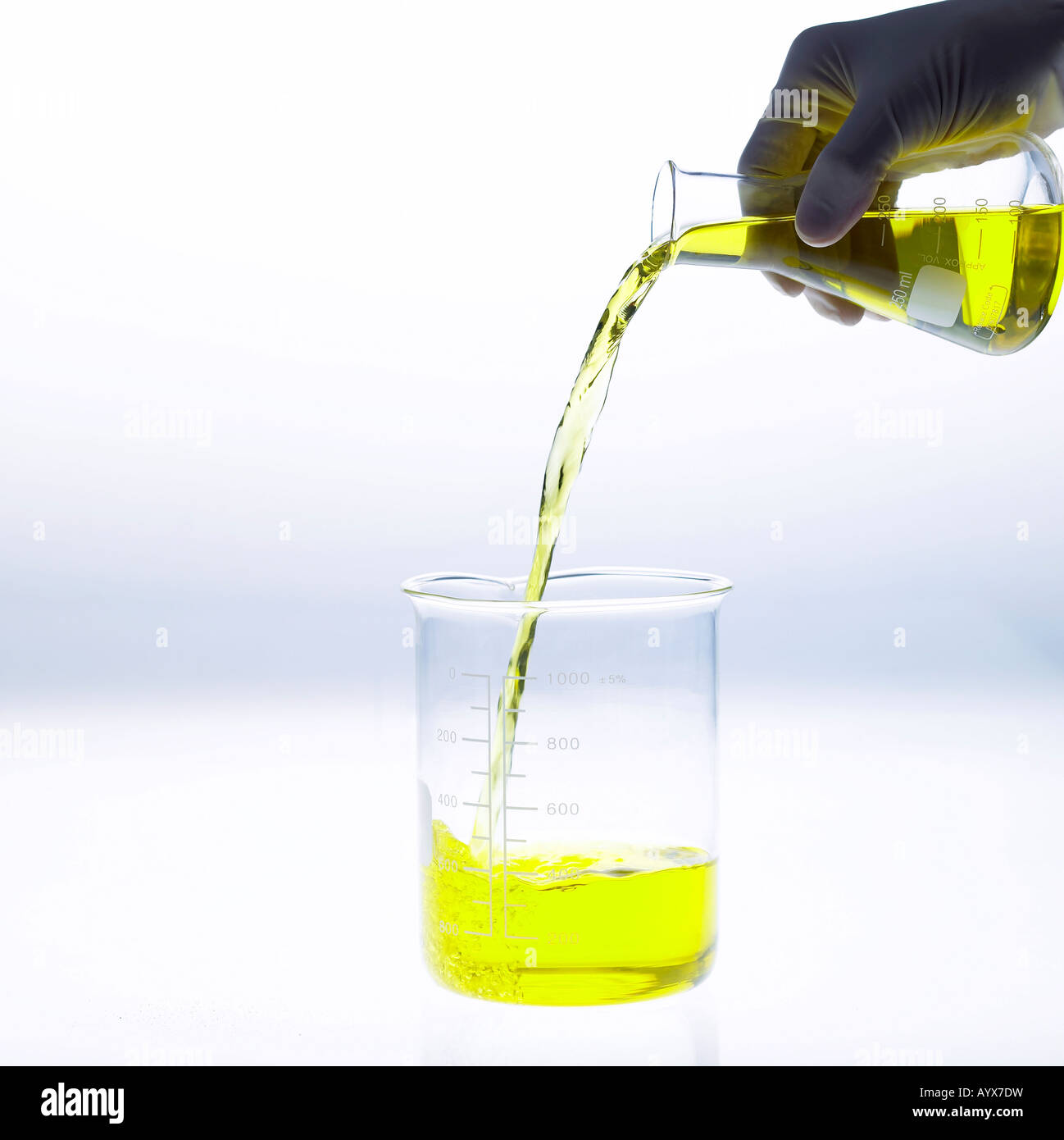 Beaker with yellow fluid and triabgular flask Stock Photo - Alamy