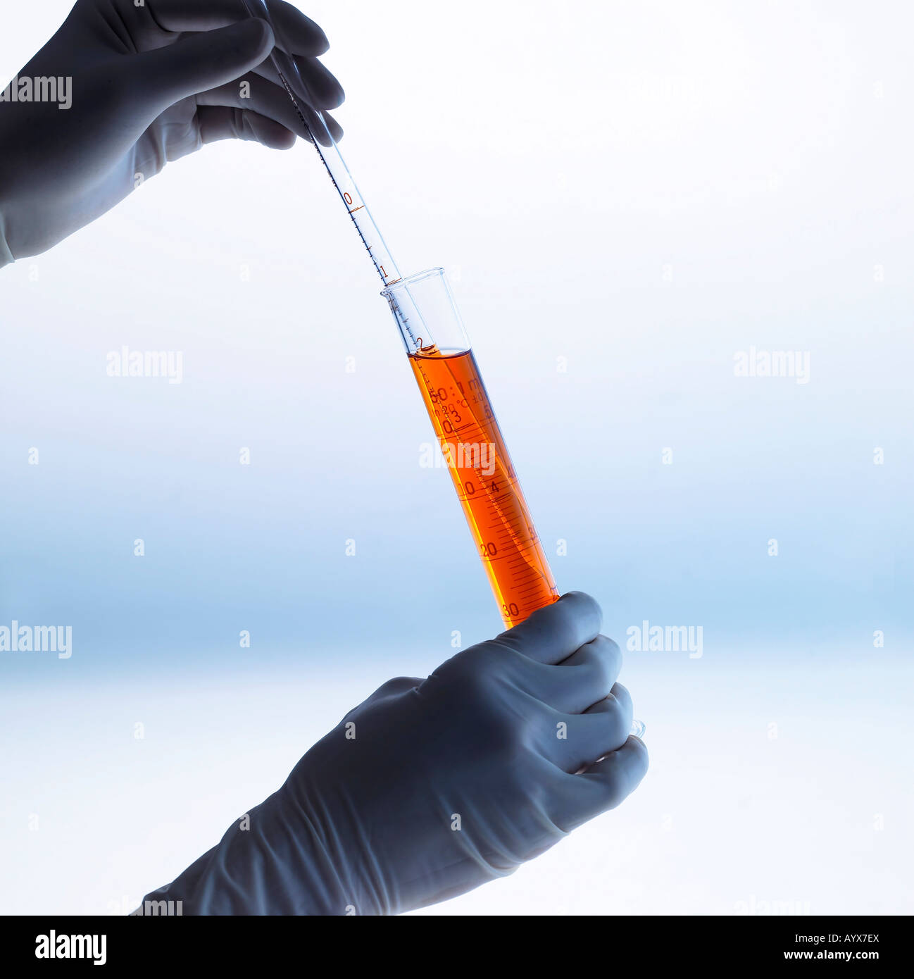 pipet and cylinder with orange fluid Stock Photo - Alamy