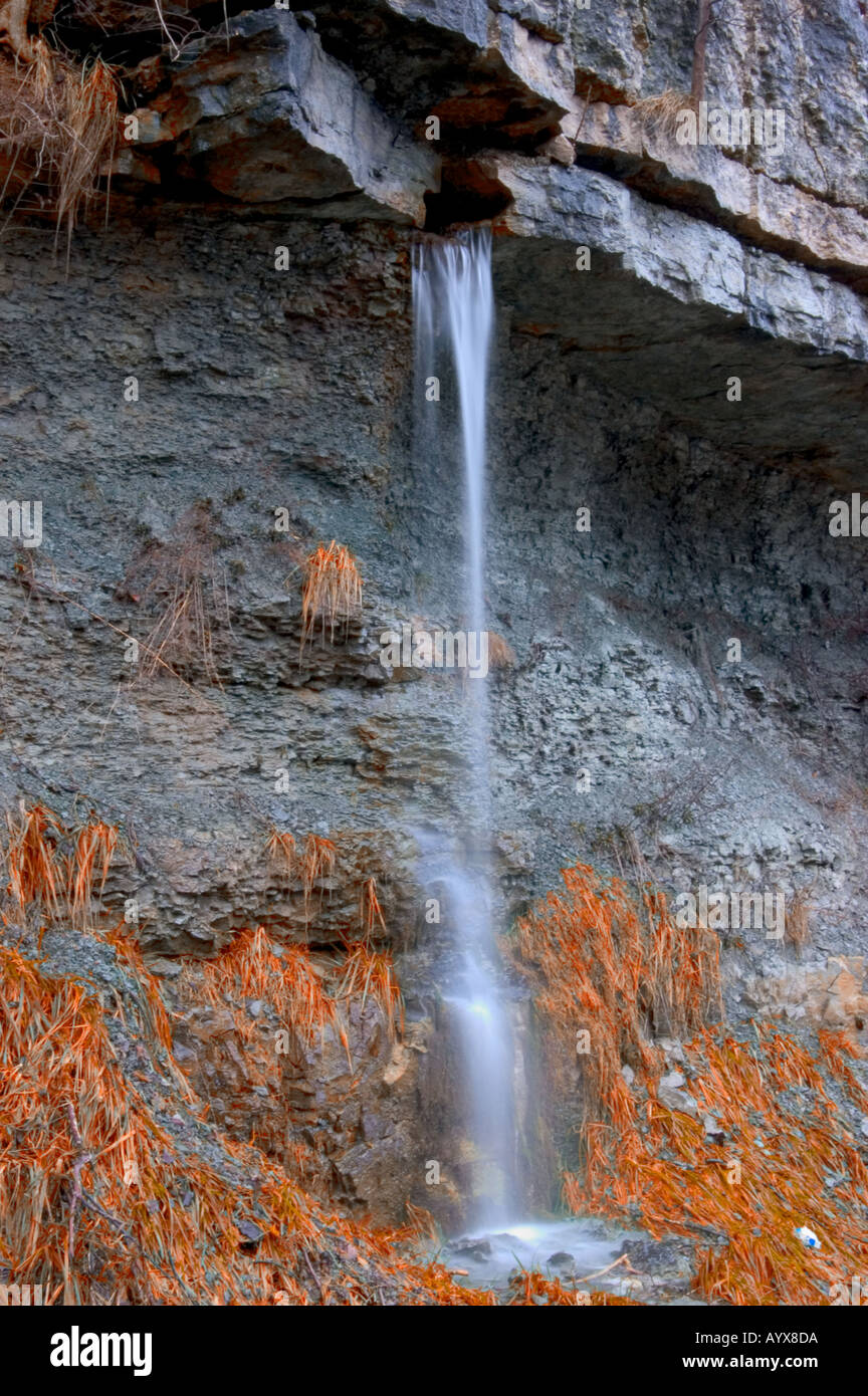 Melting snow water falling from rock ledge Stock Photo - Alamy