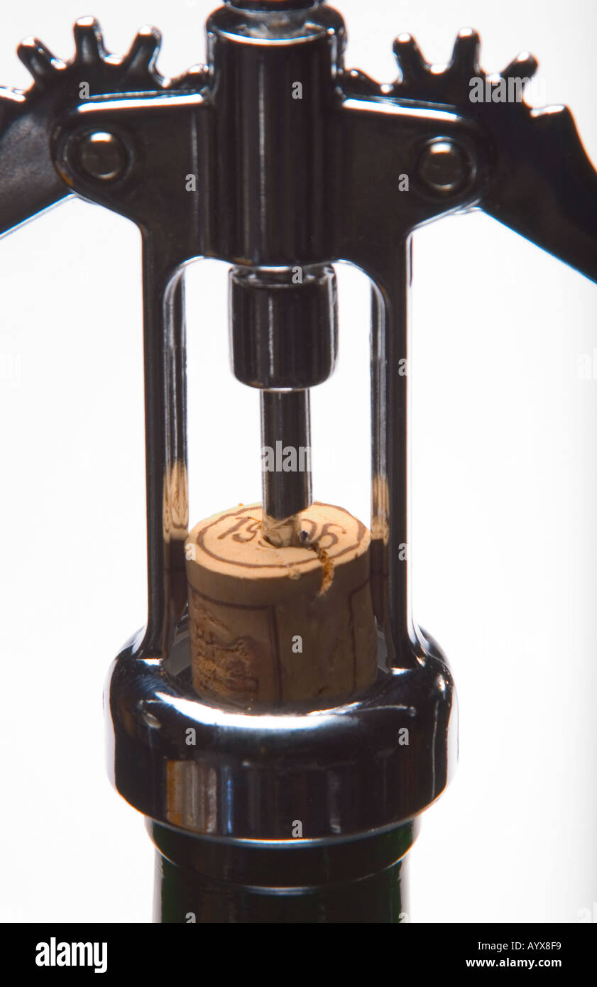 Mechanical corkscrew and wine bottle with cork close up Stock Photo - Alamy
