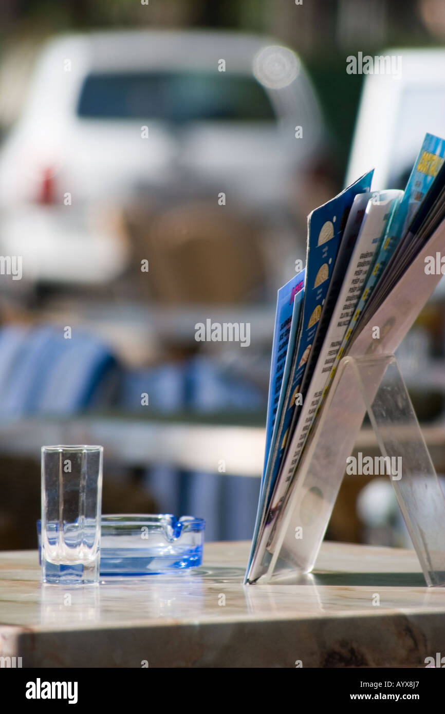 Empty glass sitting on cafe table with menu in background Stock Photo ...