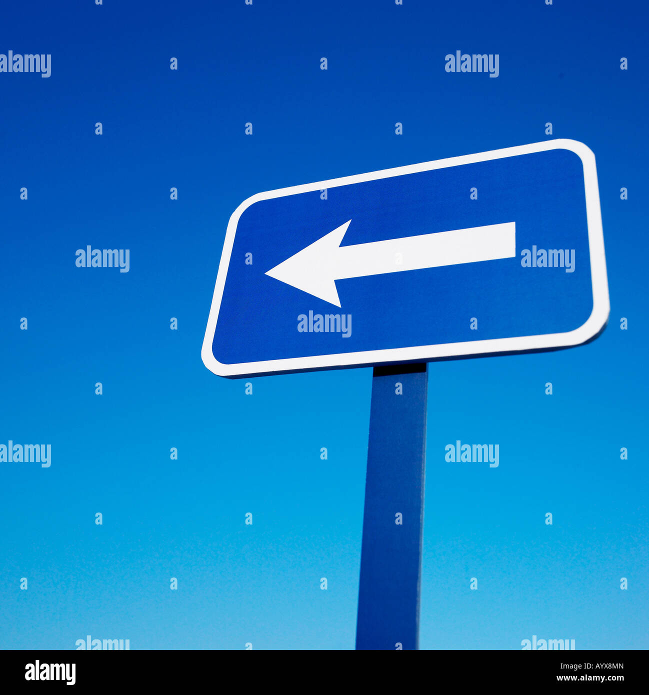 yellow arrow sign in the blue sky Stock Photo - Alamy