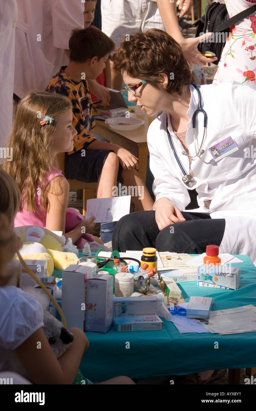 Student doctor taking to a child Stock Photo - Alamy