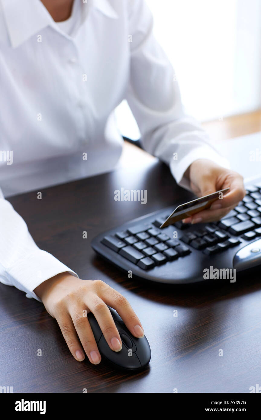 man touching card and mouse while sitting on the chair Stock Photo - Alamy
